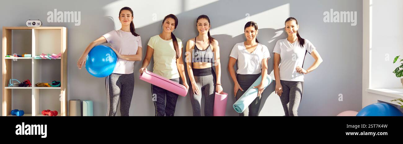 Happy Women Athletes Holding Sports Equipment During Workout In Gym ...