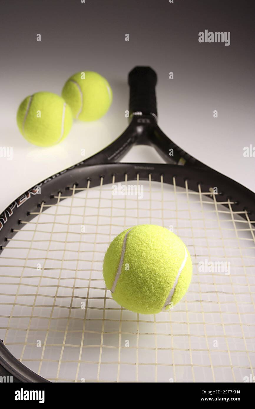 Tennis balls three green color with tennis racket racquet Stock Photo ...
