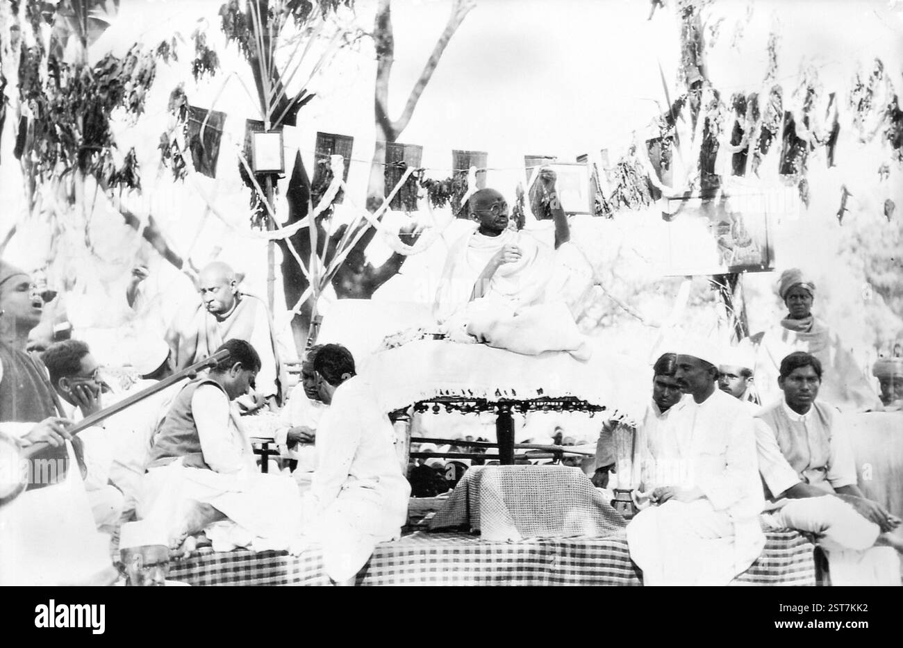 Mahatma Gandhi playing his takli spindle at a public meeting, 1929 ...