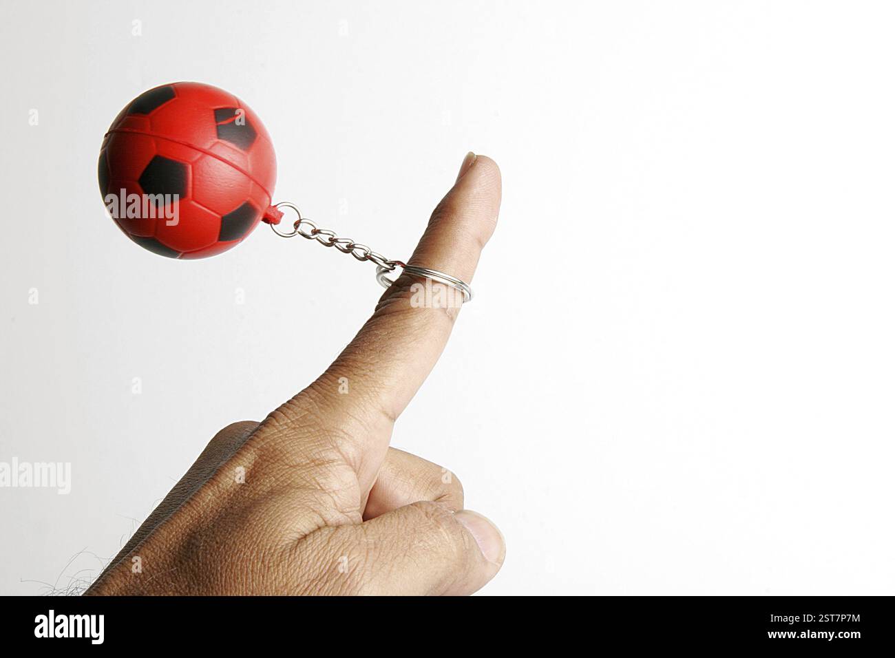 Spinning key chain made of small red and black rubber football Stock ...