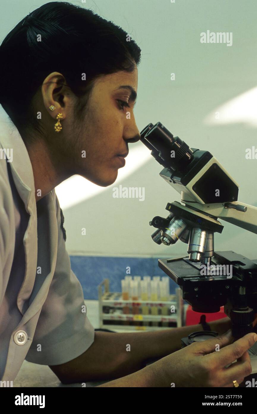 Asian scientist looks microscope hi-res stock photography and images ...