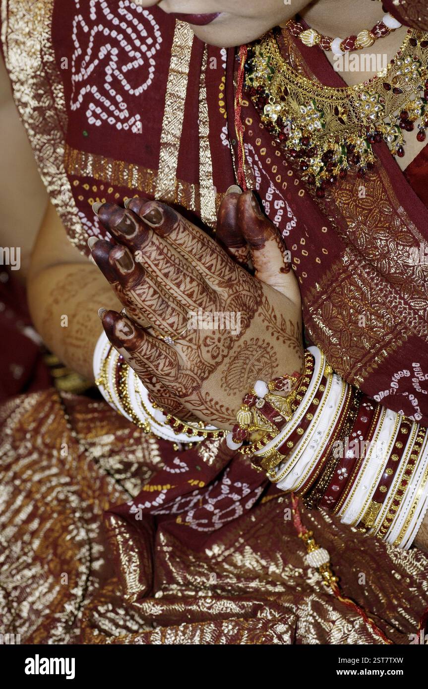 South Asian Indian Bride wearing golden bangles and showing meander ...