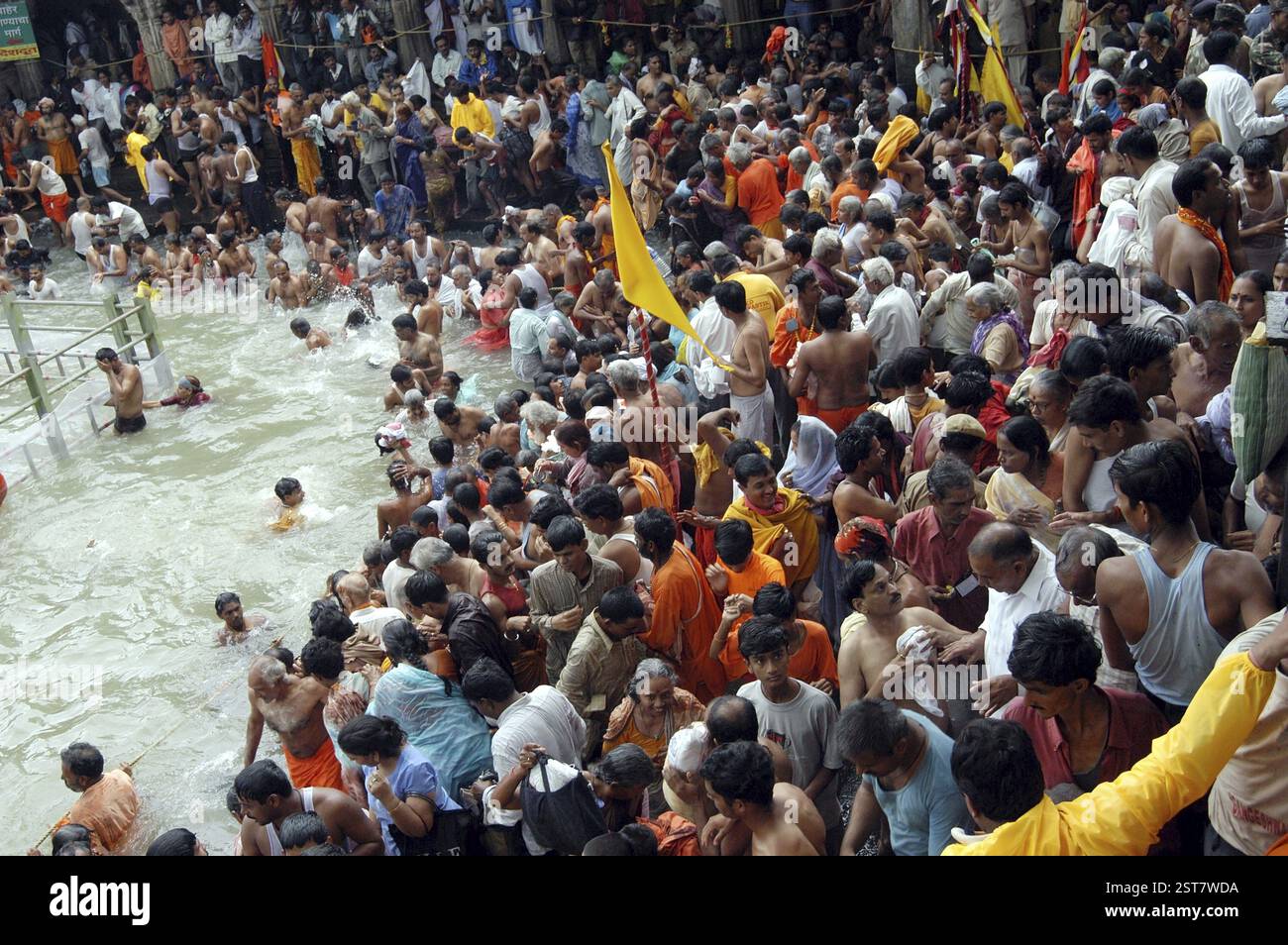 Devotees take a holy dip during the Kumbh Mela 2003 at Trimbakeshwar ...