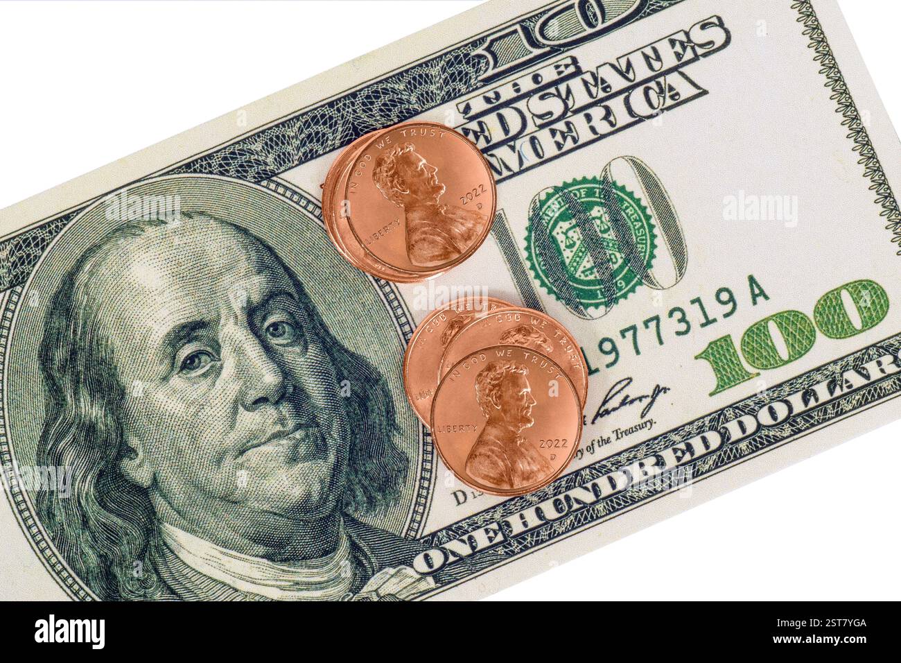 Horizontal shot of six Lincoln pennies on a Ben Franklin one hundred ...