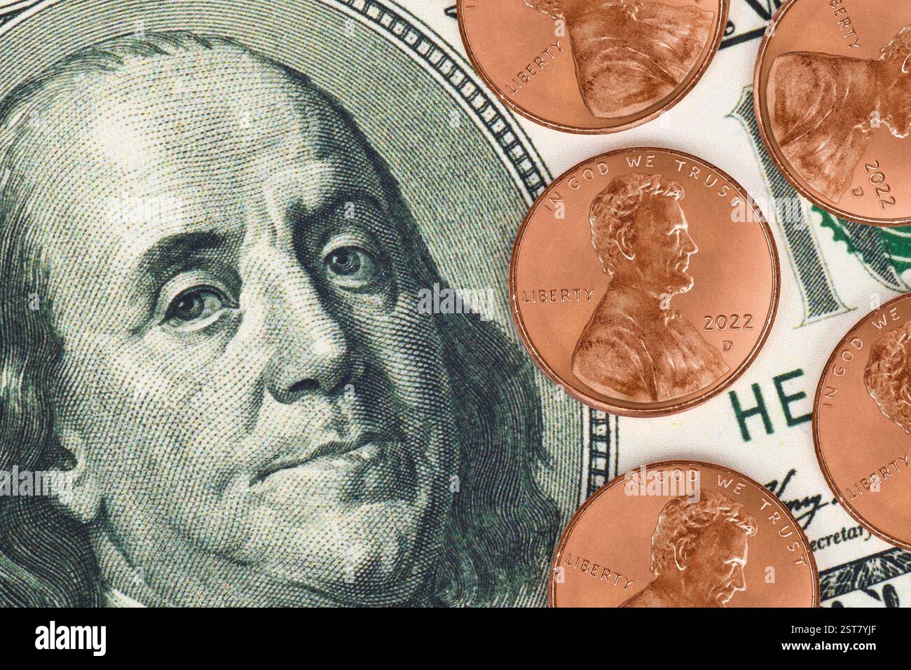 Horizontal shot of five pennies on a Ben Franklin one hundred dollar ...