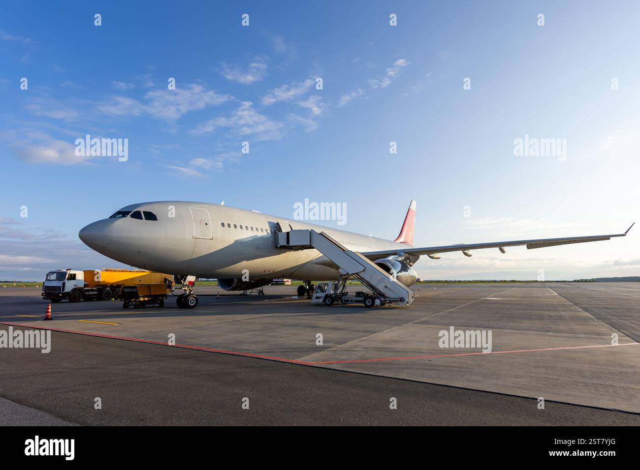 Wide body passenger jetliner with aircraft steps at the airport ...