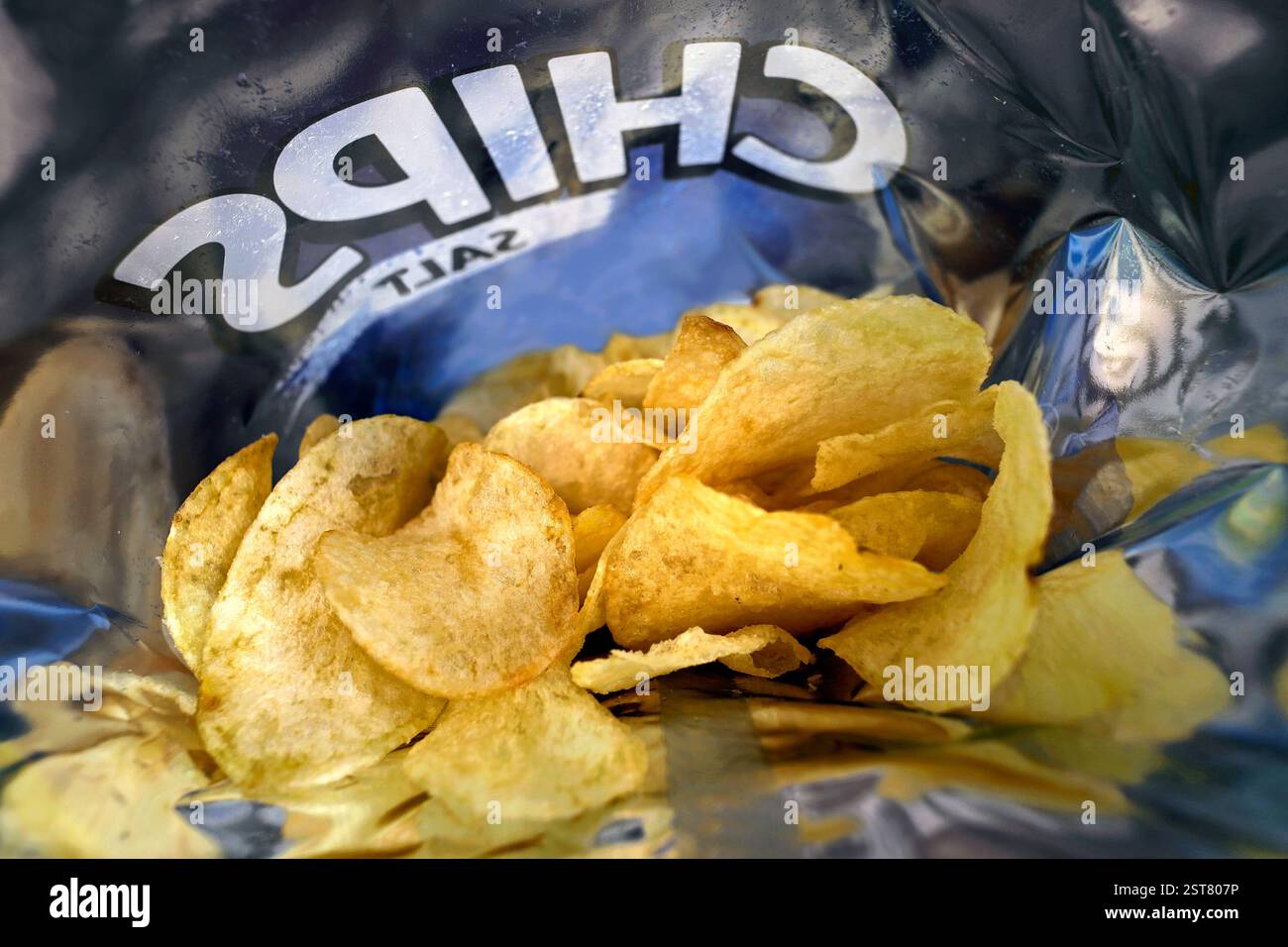 Close-up of the inside of a package of salted potato chips, chips in a ...