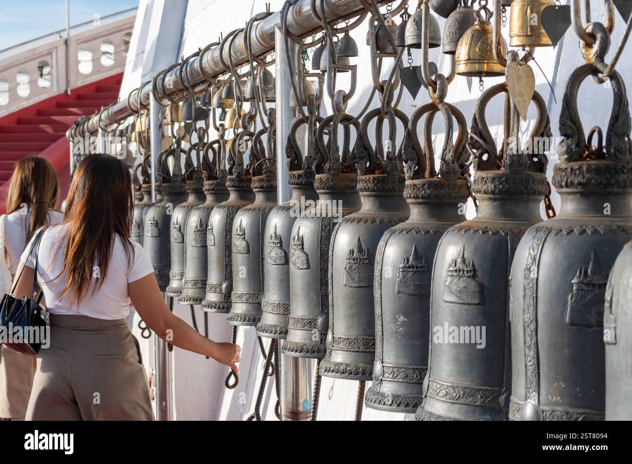 Thai women ringing the devotional bells at Wat Saket or The Golden ...