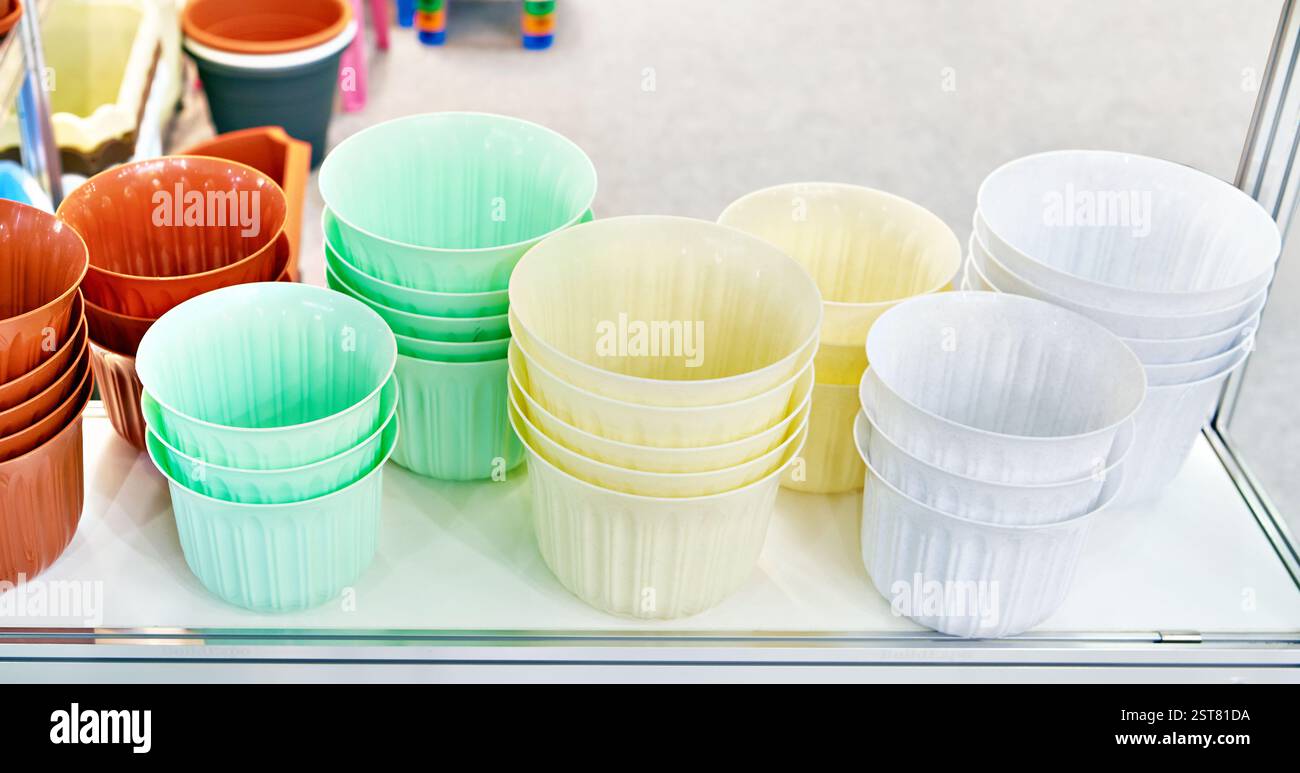 Colored plastic plant pots in store Stock Photo - Alamy