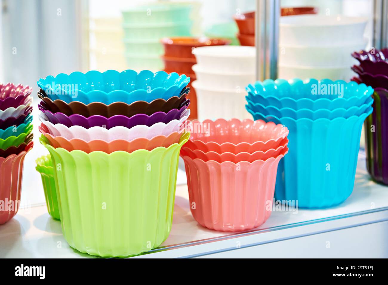 Colored plastic plant pots in store Stock Photo - Alamy