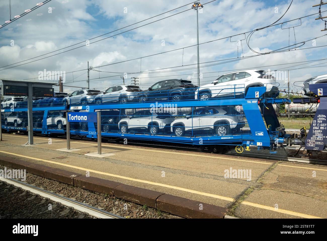 Freight train with new cars on board Stock Photo - Alamy