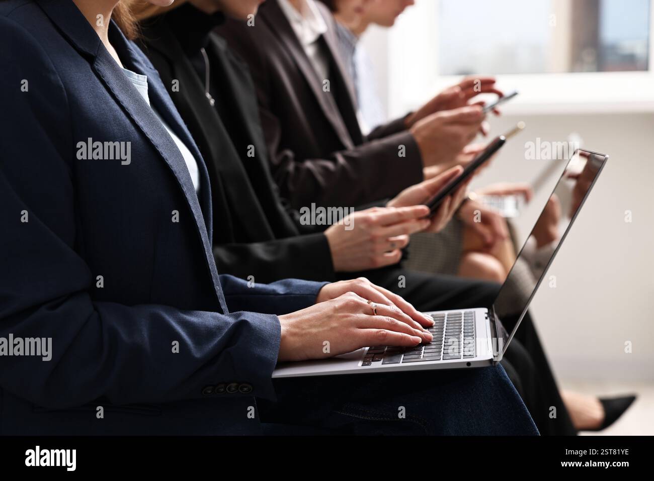 Group of people using different gadgets indoors, closeup. Modern ...