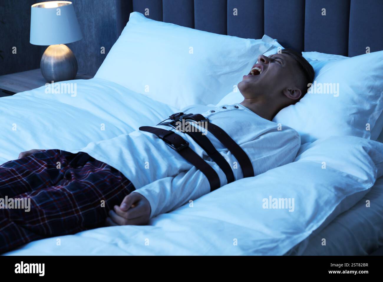 Man in sleepwalking condition screaming on bed Stock Photo - Alamy