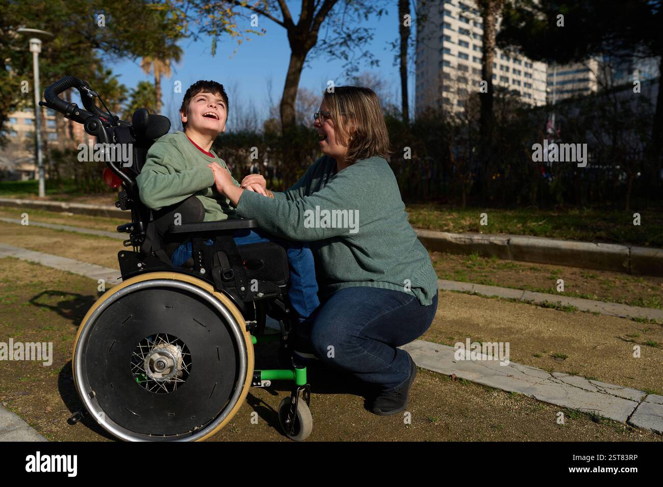 Happy boy with cerebral palsy enjoying park stroll with nurse Stock ...