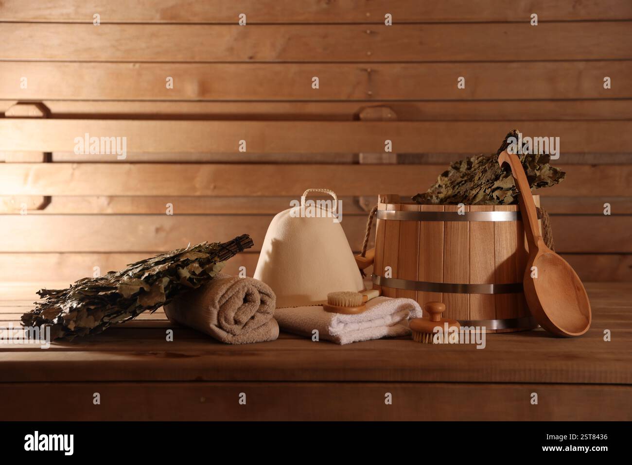 Bucket, whisks, massaging brushes and other equipment on wooden bench ...