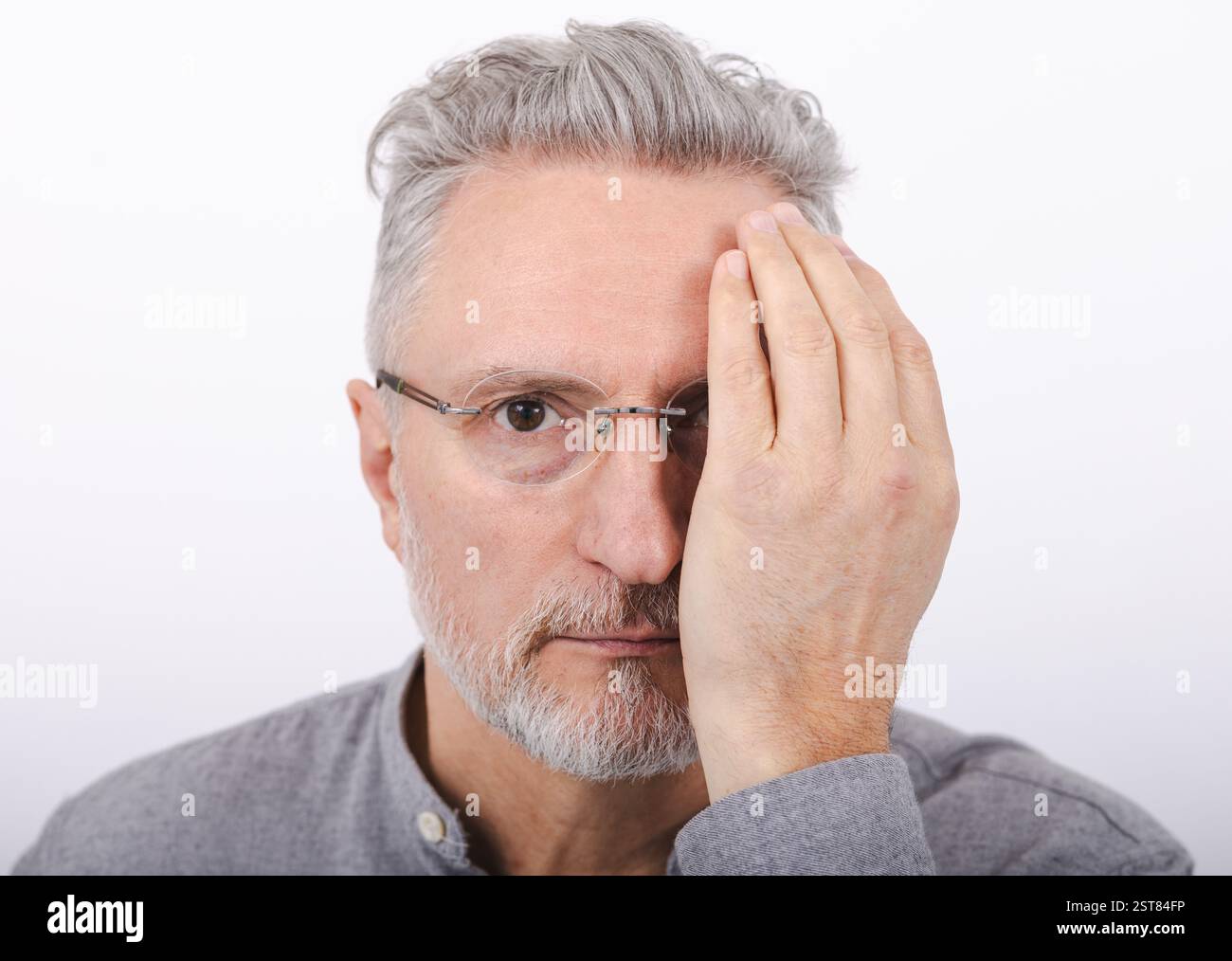Portrait of senior man wearing stylish glasses to treat his poor ...