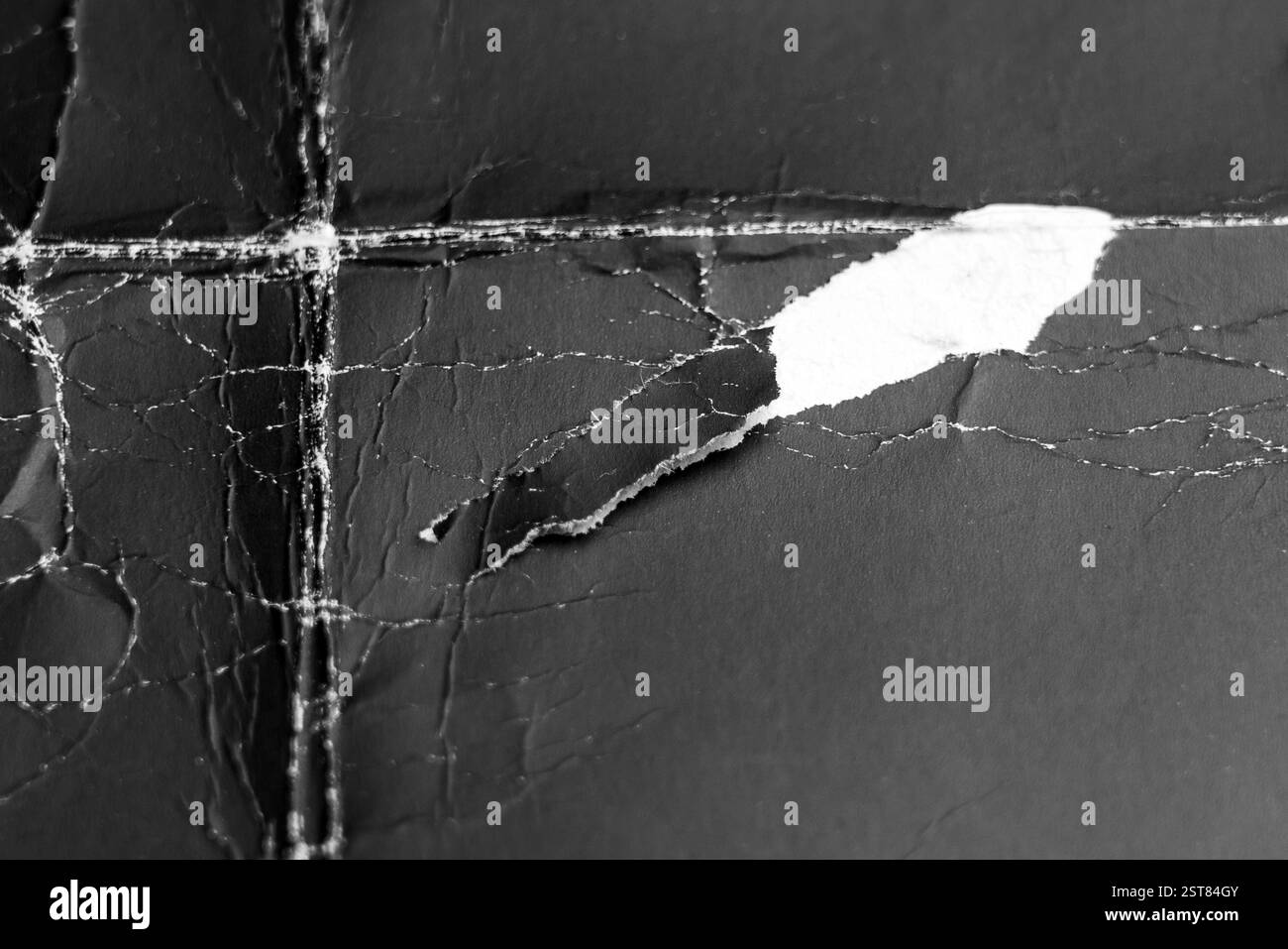 Black white close-up of cracked cardboard surface. Torn paper and ...