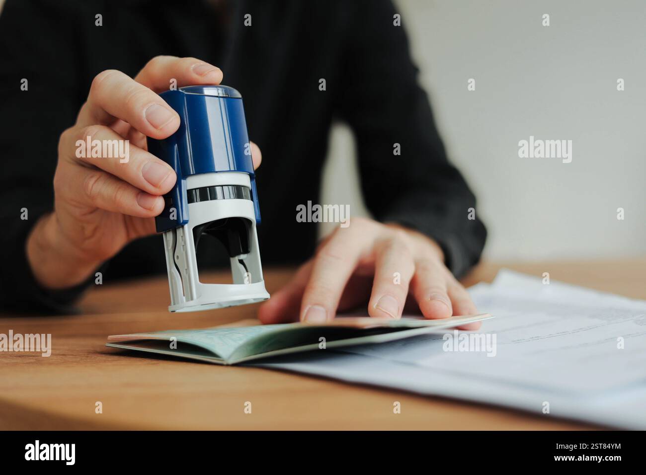 Man border control worker puts a stamp in the passport. Tourism ...