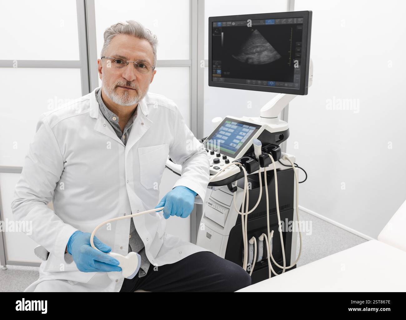 Portrait of a sonographer doctor near an ultrasound machine in a ...