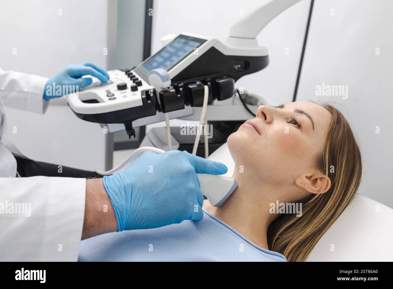 Woman patient receives thyroid diagnostics. Treatment of thyrotoxicosis ...