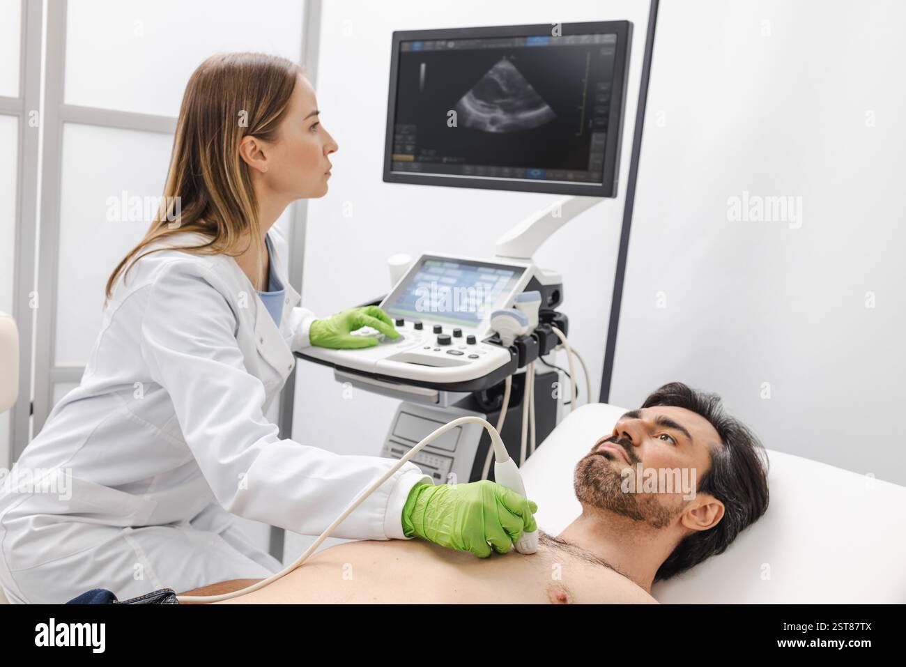 Heart ultrasound exam for male patient with ultrasound specialist while ...