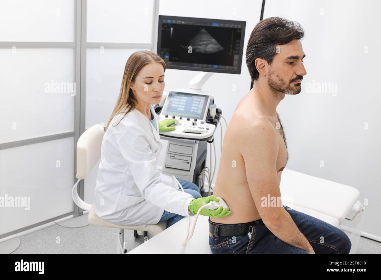 Renal and kidney ultrasound. Patient having kidneys sonography check-up ...