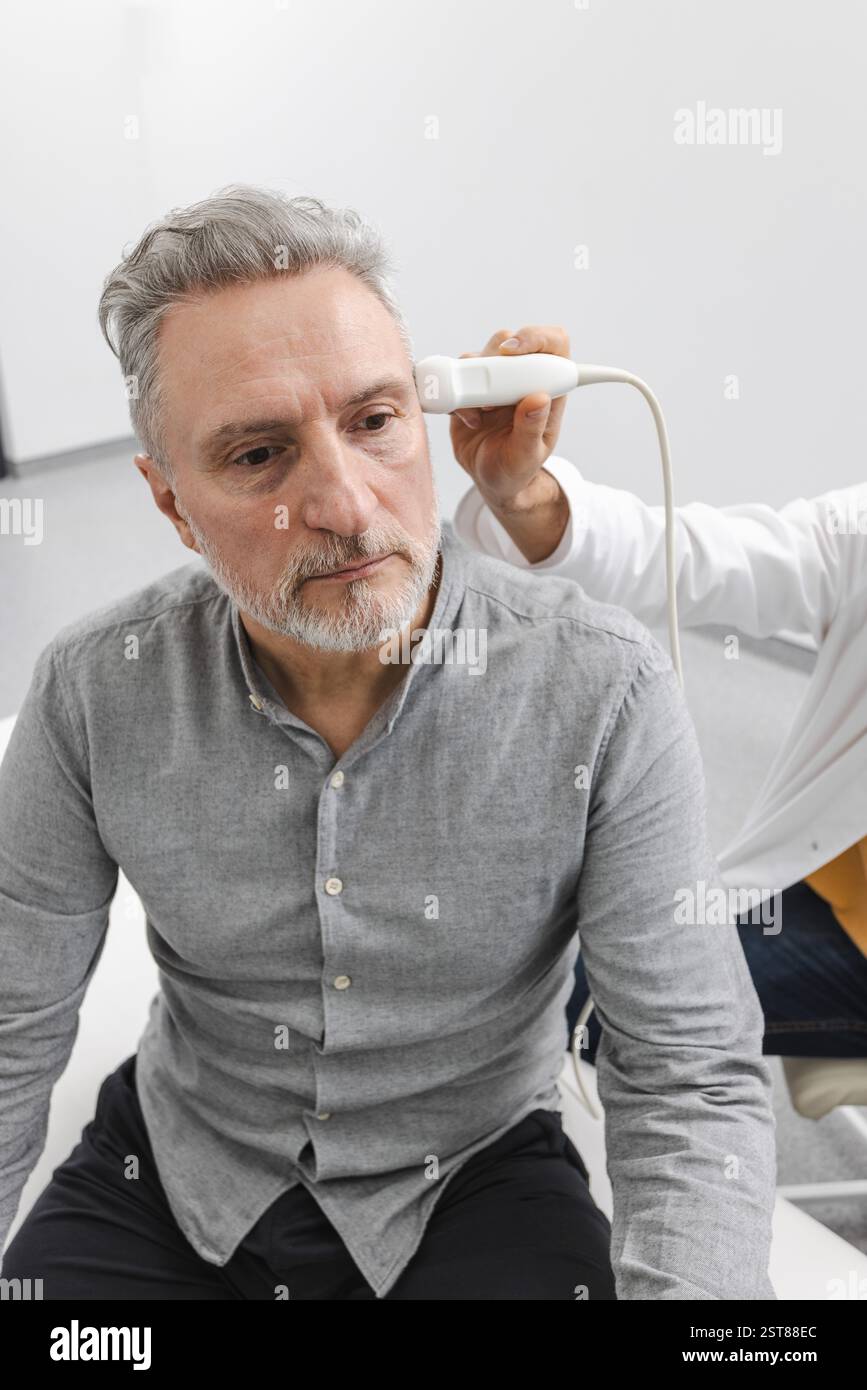 Vascular scientist using ultrasound scanning machine for examining ...