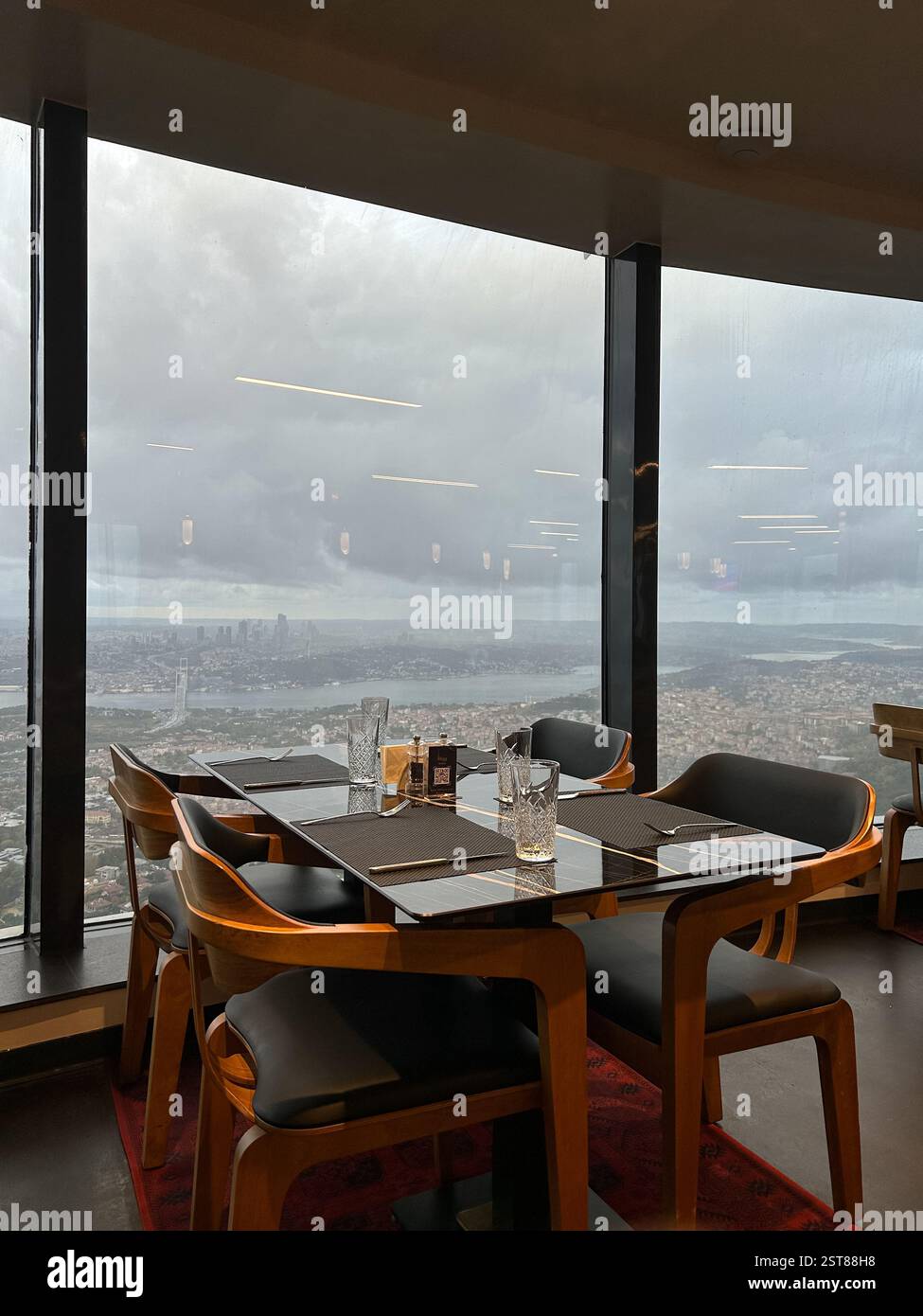 This stunning photograph captures a high-rise restaurant with floor-to ...