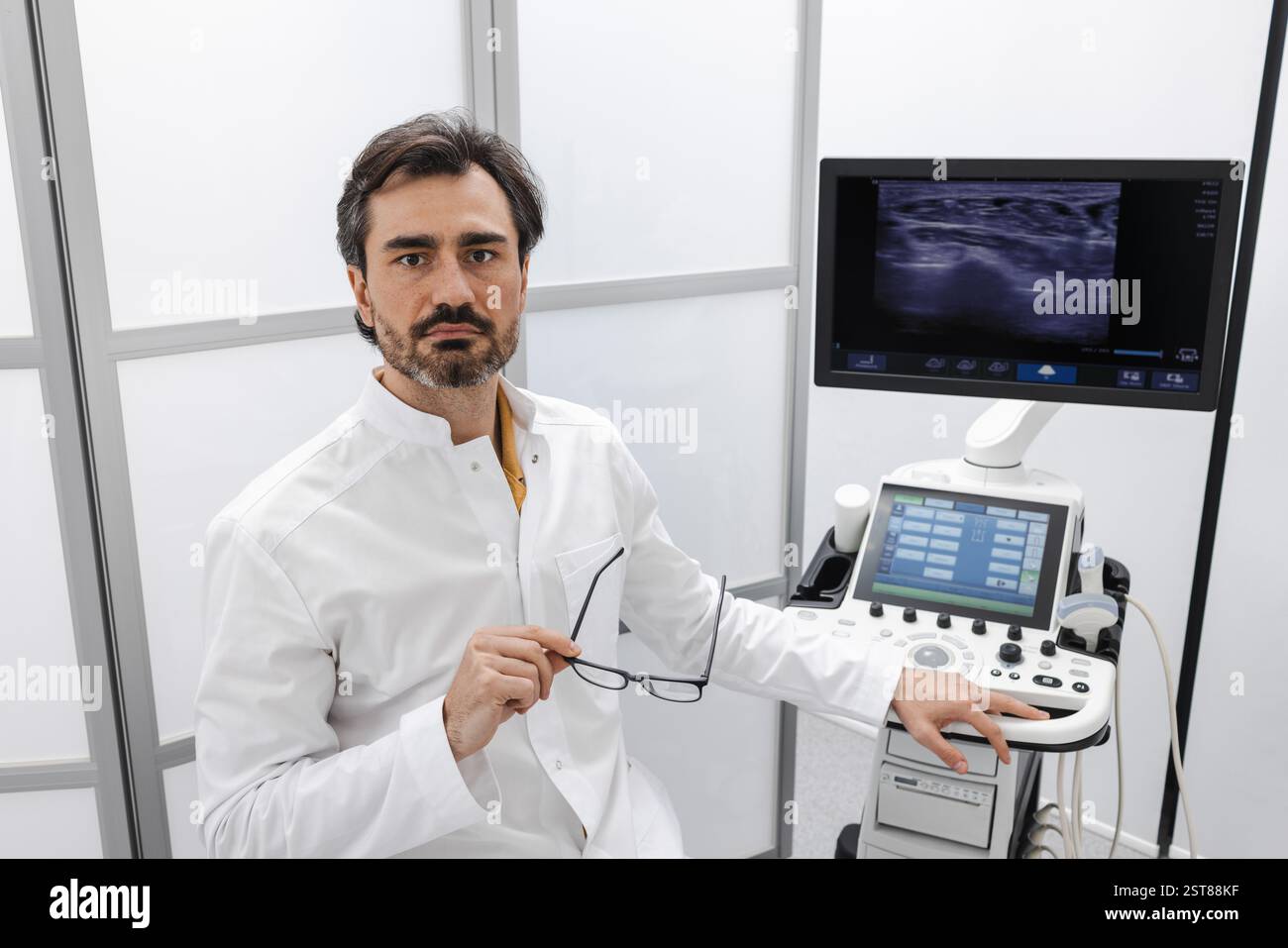 Sonographer occupation. Portrait of male sonographer near ultrasound ...