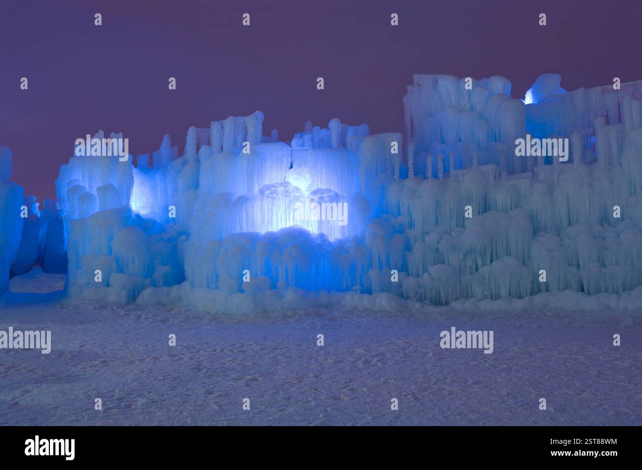 ice structure illuminated with blue lights behind ice walls and layers ...