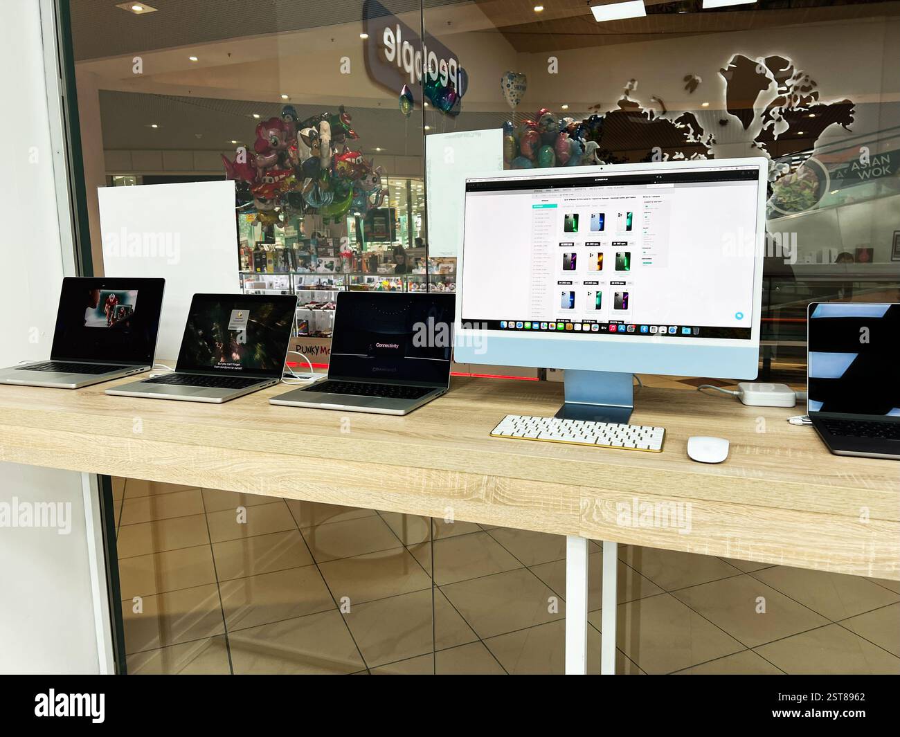 Lviv, Ukraine - February 16, 2025: A row of Apple laptops and desktops ...