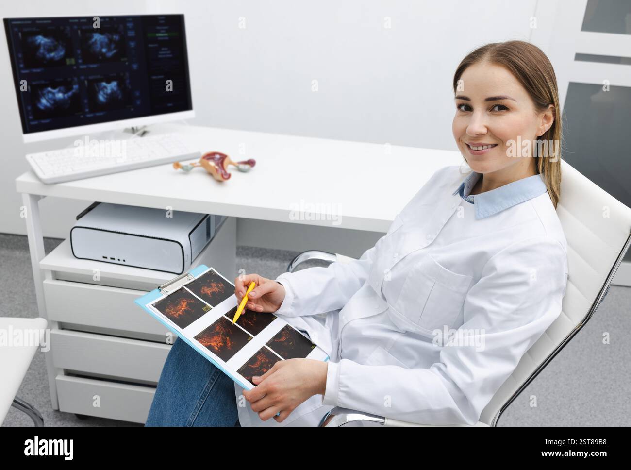 Portrait of positive female gynecologist in gynecological examination ...
