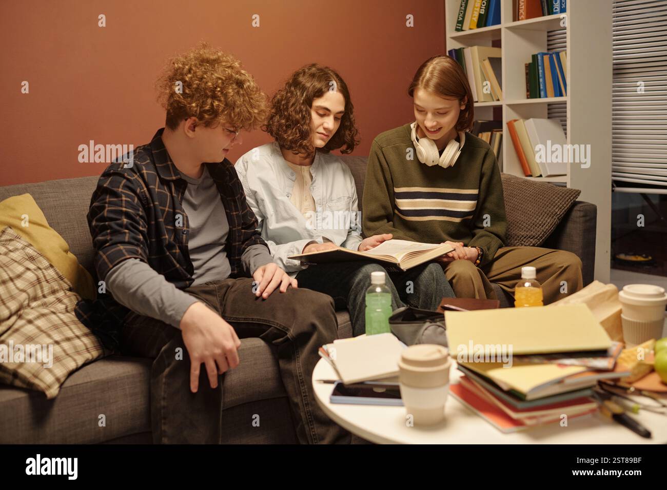 Three Students Reading Book Stock Photo - Alamy