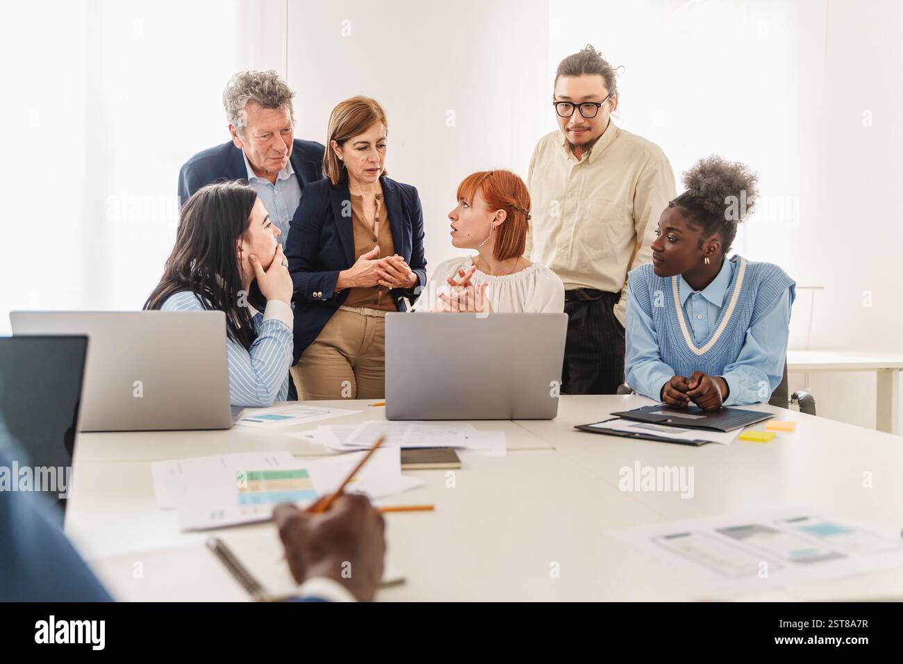 Diverse team of professionals collaborating in a modern office ...