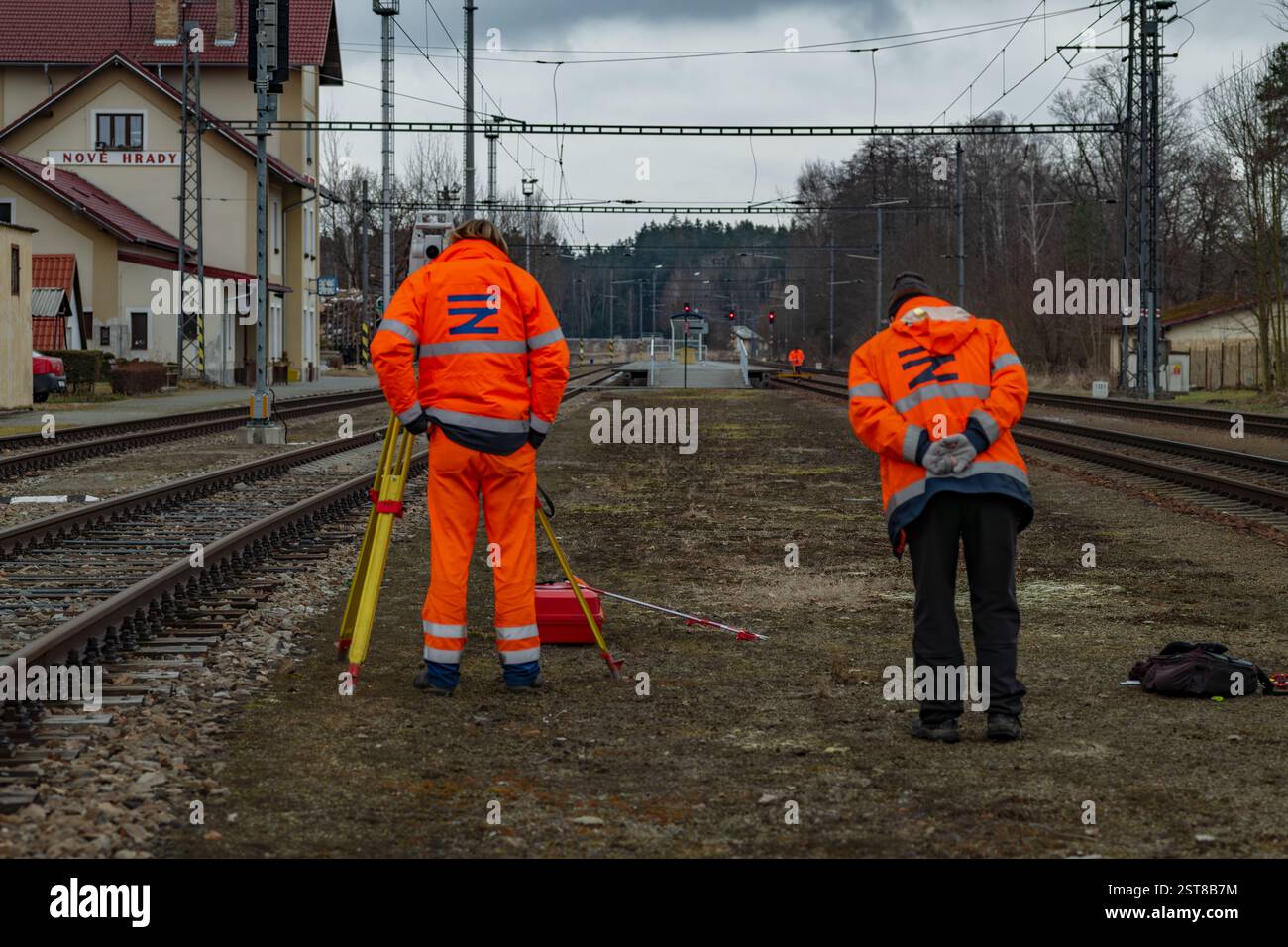 Railway surveyors with electric passenger unit train in station Nove ...