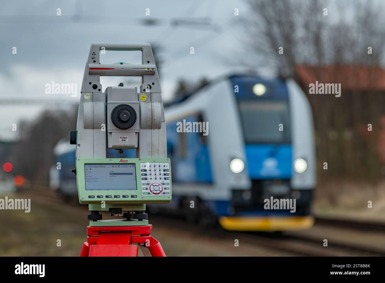 Railway surveyors with electric passenger unit train in station Nove ...