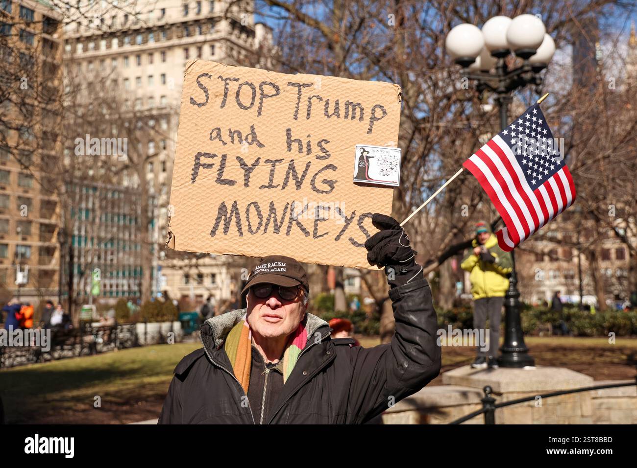 A man holds up a placard opposed to the policies of President Donald ...