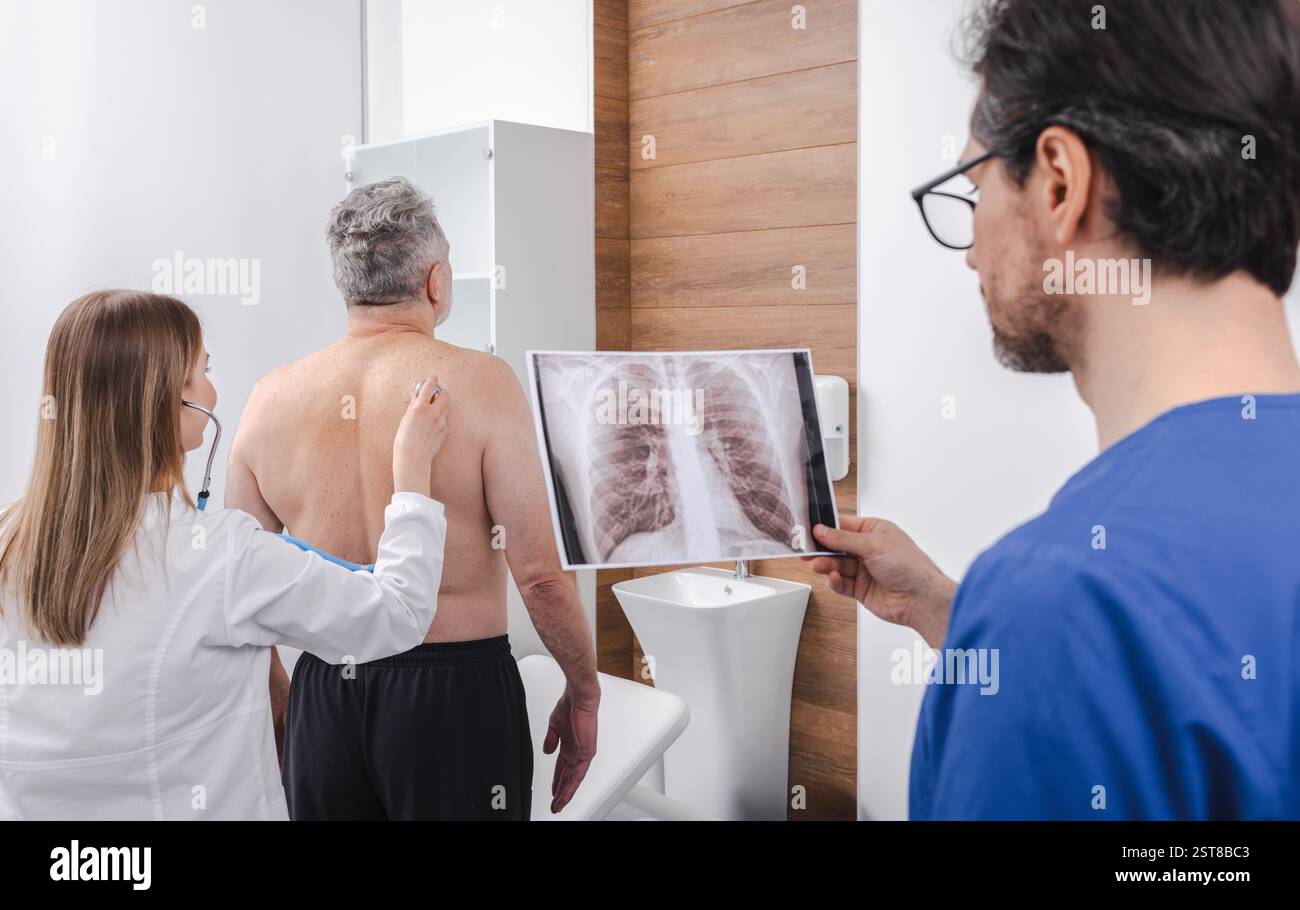 Senior patient is examined by a doctor pulmonologist in medical clinic ...