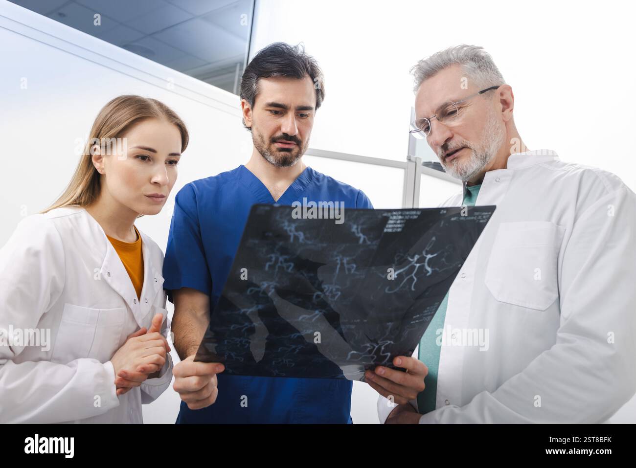 Three healthcare professionals, including two doctors and a nurse ...