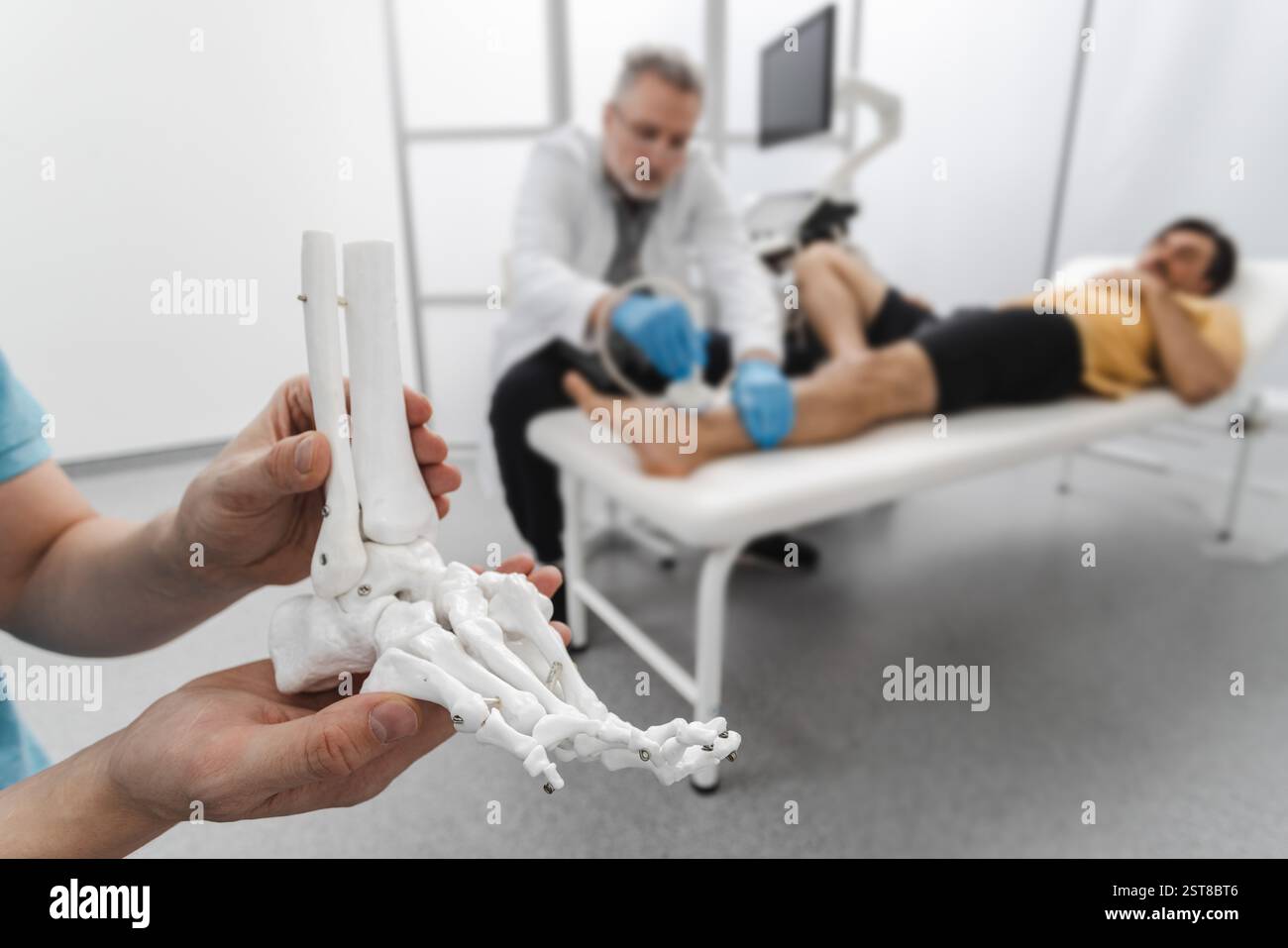 Anatomical model of foot bones on background of process of diagnostics ...