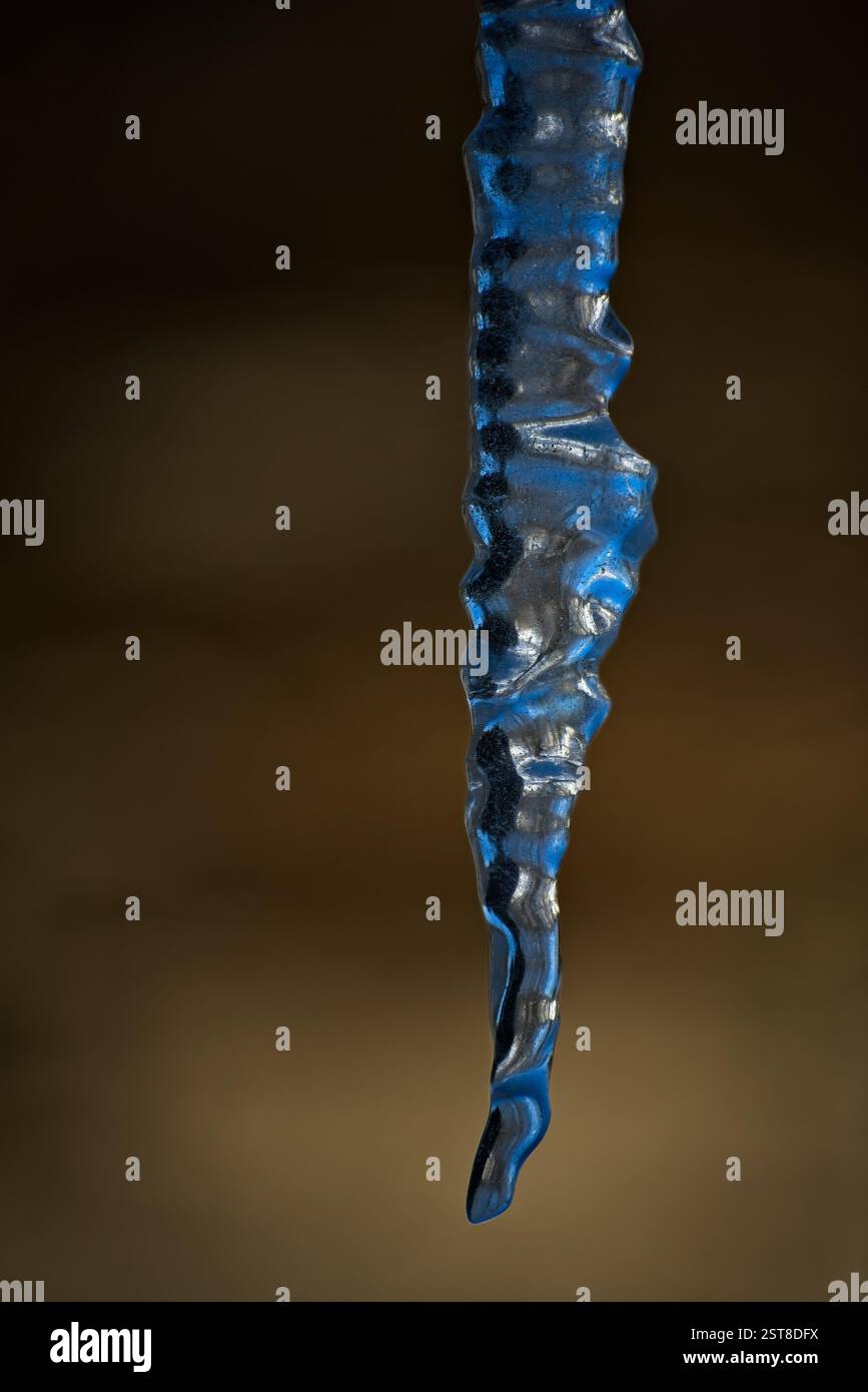 A blue tinted icicle somewhat resembling an elongated ballet slipper ...