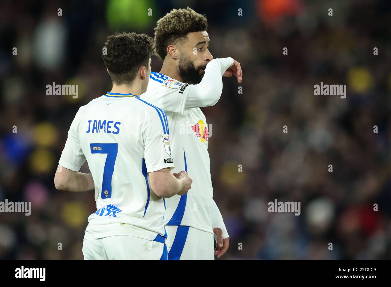 Daniel James converses with Jayden Bogle of Leeds United during a break ...