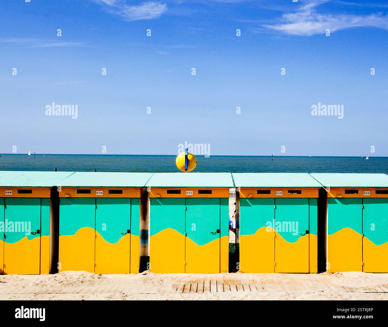 A peaceful seaside retreat featuring traditional yellow and green beach ...
