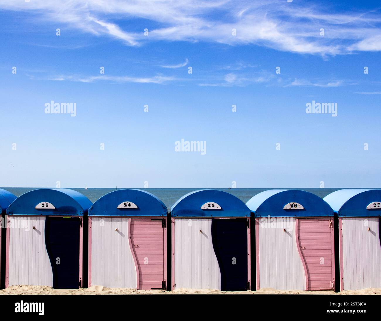 The charm of the seaside is embodied in a row of quaint blue and pink ...
