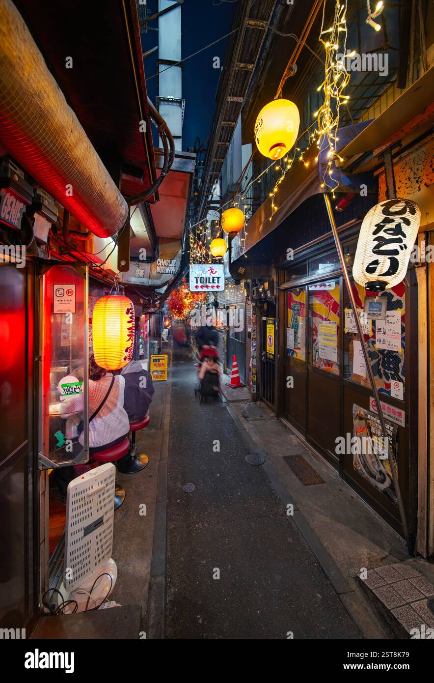 tokyo, shinjuku - jan 13 2025: A bustling night scene in Shinjuku Omoide Yokocho featuring a ...