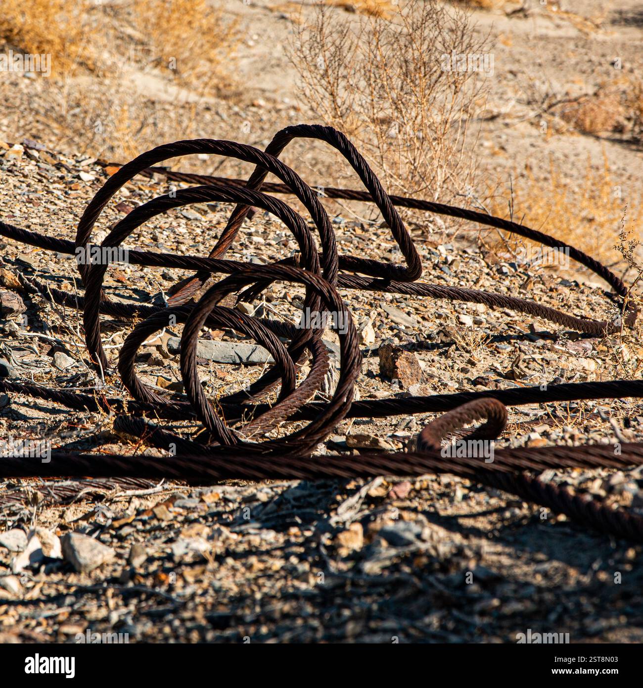 Loops of old rusted steel cable at an old mining site in the desert ...