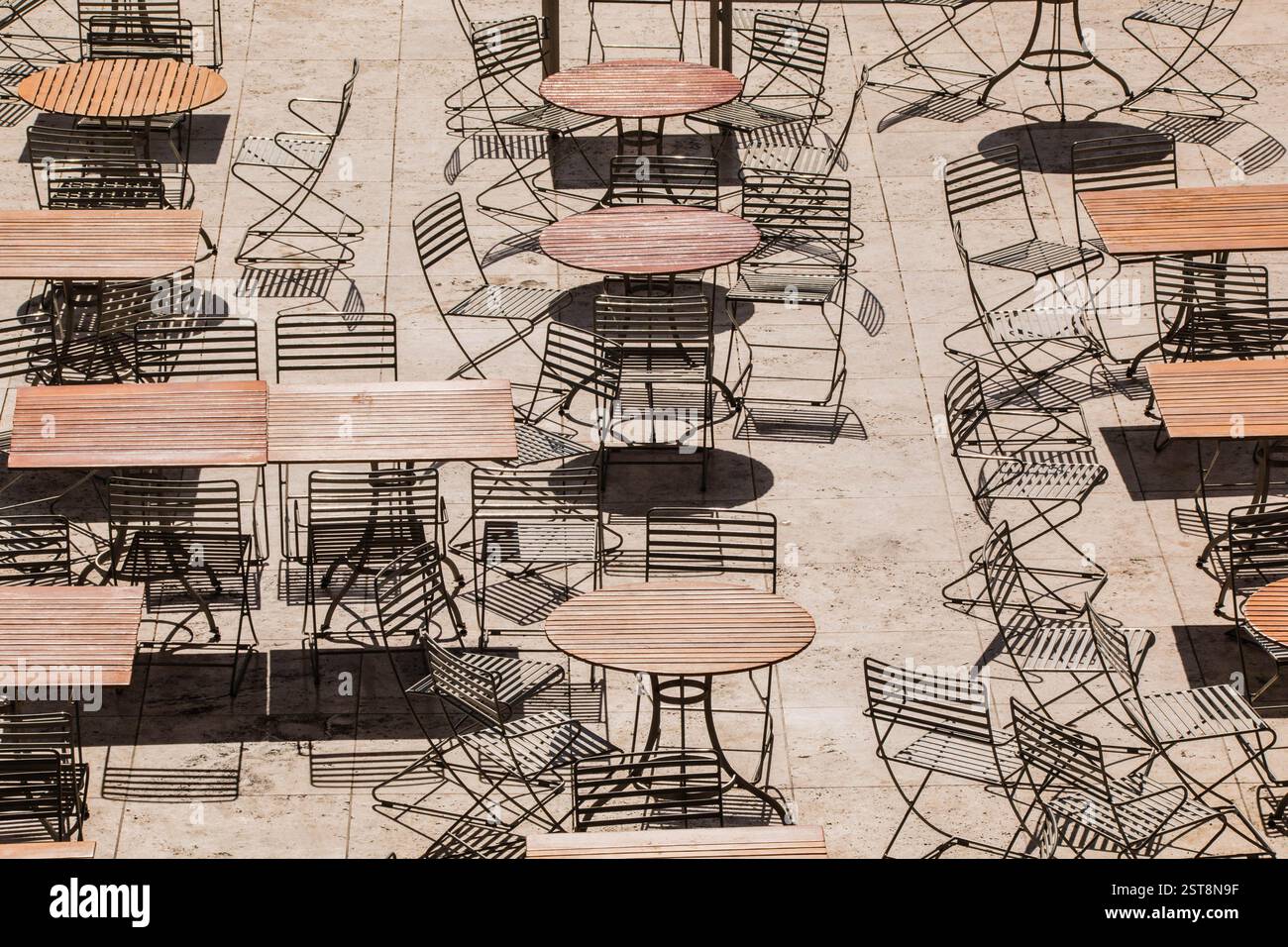 Overhead view of empty tables and chairs at an outdoor dining area at ...