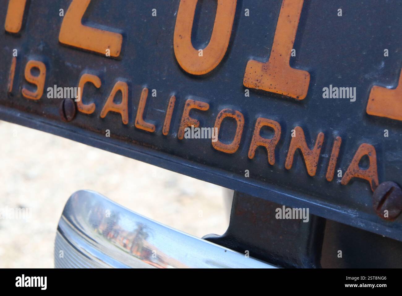 A vintage black and yellow California license plate on a classic car ...