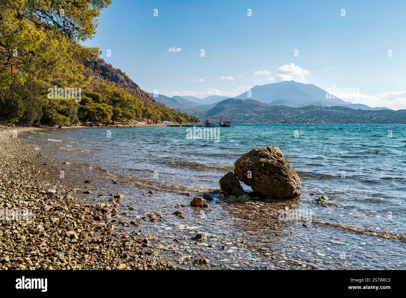 A tranquil shoreline at Limni Vouliagmenis in Loutraki, Greece ...