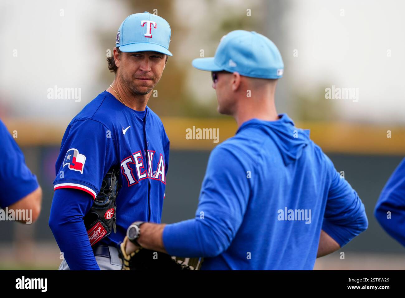 Texas Rangers starting pitcher Jacob deGrom warms up with other ...